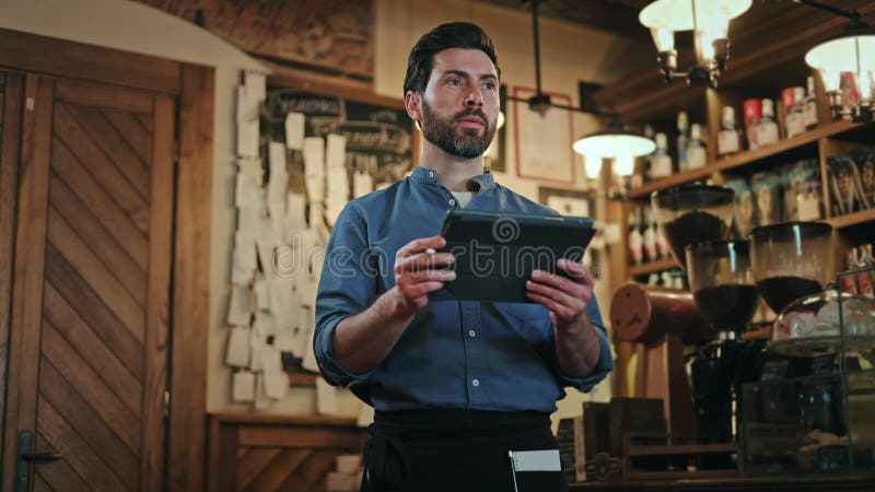 Cafe Worker Holding Handheld Order-taking Device and Tending Customers ...
