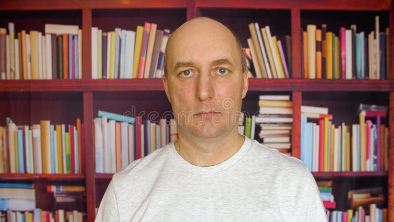 Serious Man in the Library. Close Up View Man with a Bald Head in Front ...