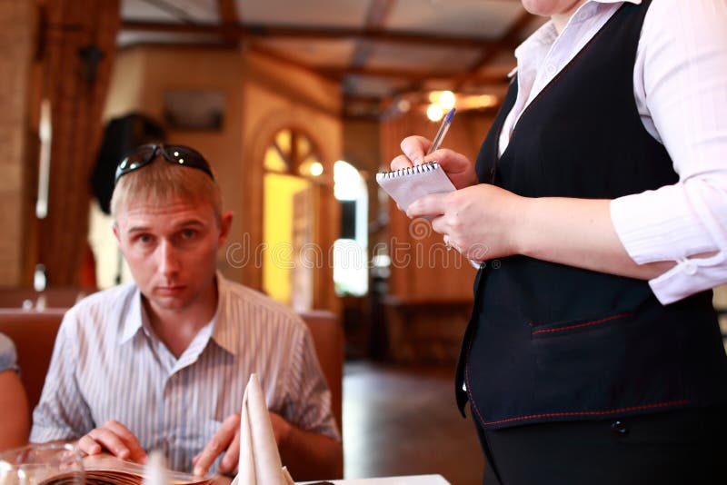 Serious man orders dish stock photo. Image of offer - 166403300