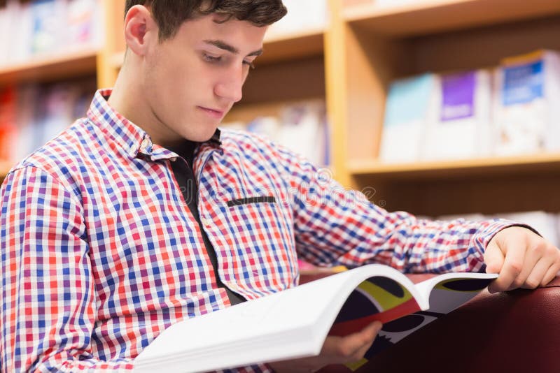 Serious Man Reading Book in Library Stock Image - Image of focus, shot ...