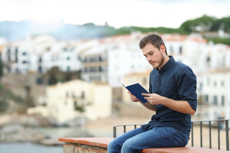 Serious Man Reading a Paper Book in a Coast Town Stock Photo - Image of ...