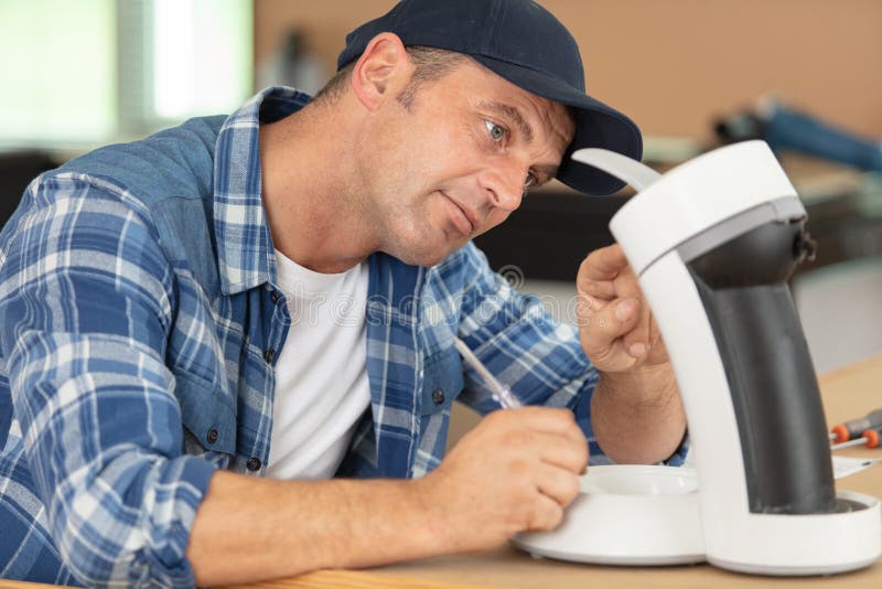 Serious Man Repairing Broken Coffee Machine Stock Photo - Image of neat ...