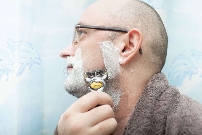 Serious Man Shaving His Beard by Razor Blade Stock Photo - Image of ...