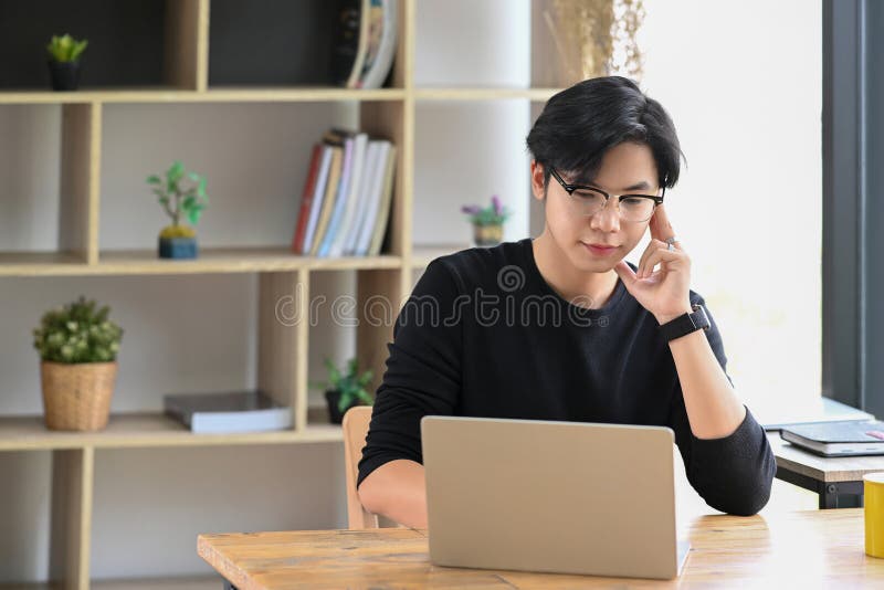 Serious Man Sitting in the Creative Office and Working with Laptop ...