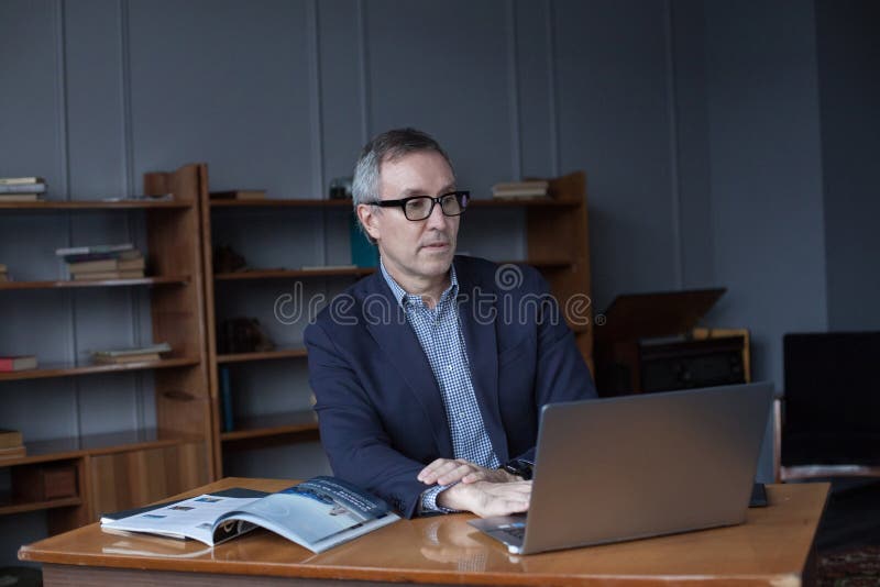 Serious Man Sitting at the Deck and Using Laptop for Business Project ...