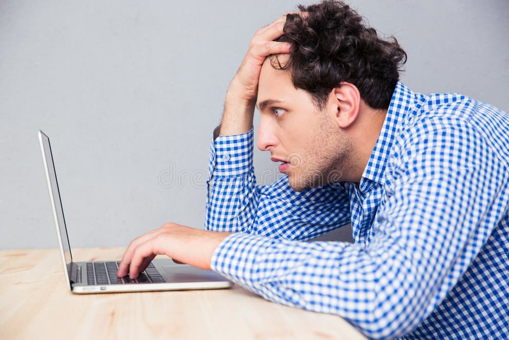 Serious Man Sitting at the Table and Using Laptop Stock Image - Image ...