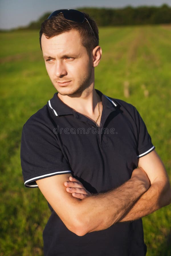 Serious Man Standing in Field on the Grass Stock Photo - Image of ...