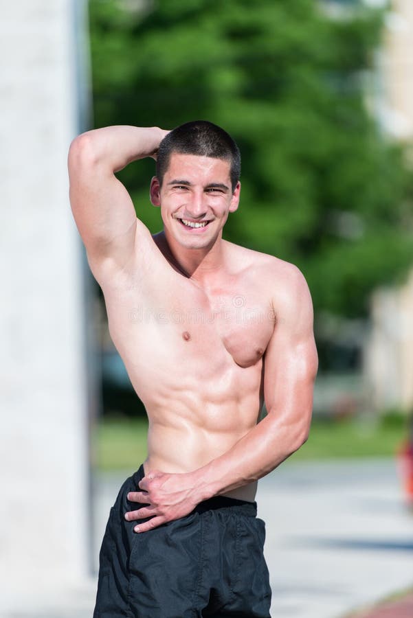 Serious Man Standing Outdoors and Flexing Muscles Stock Image - Image ...
