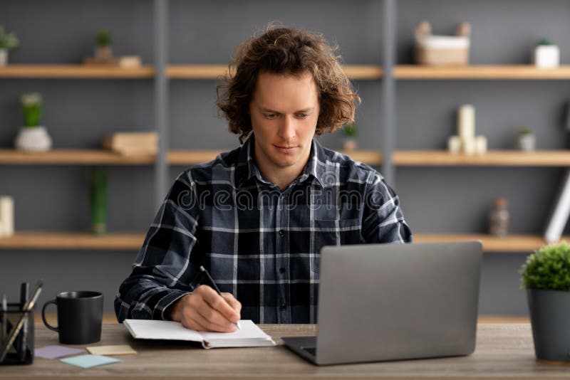Serious Man Taking Notes Sitting at Laptop Computer in Office Stock ...