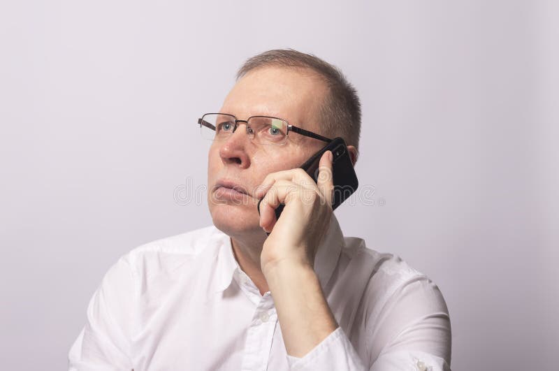 Serious Man Talking on Mobile Phone in White Shirt Stock Photo - Image ...