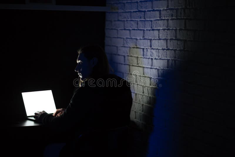 Serious Man Using Laptop Computer at Home Indoors at Night. Stock Photo ...