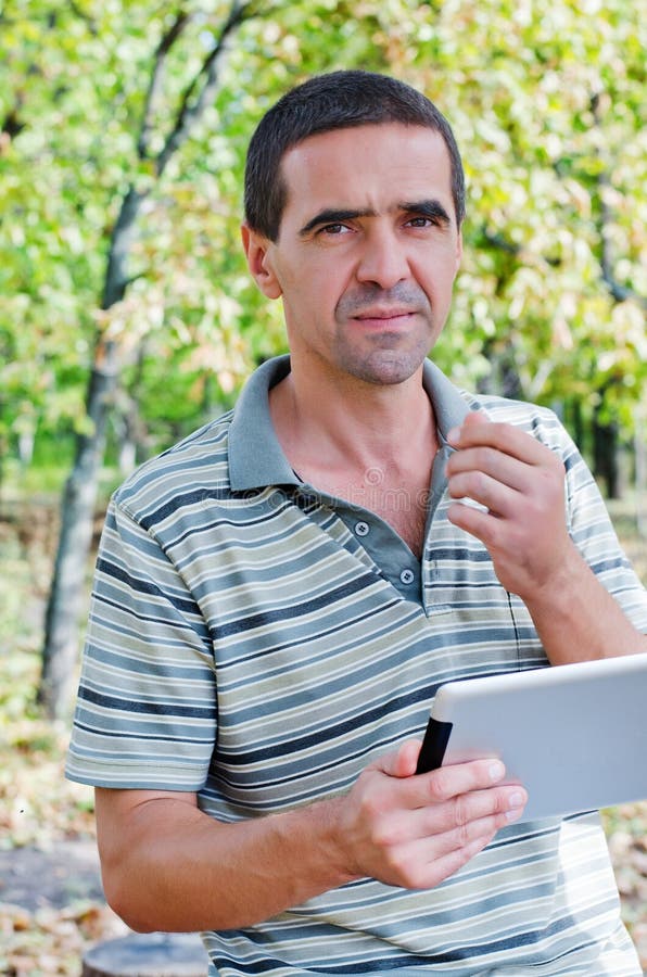 Serious man using a tablet stock image. Image of autumn - 27301013