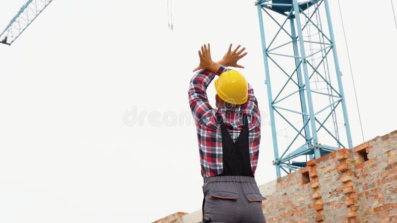 Serious Manager in Helmet and Uniform Giving Commands To Crane Operator ...