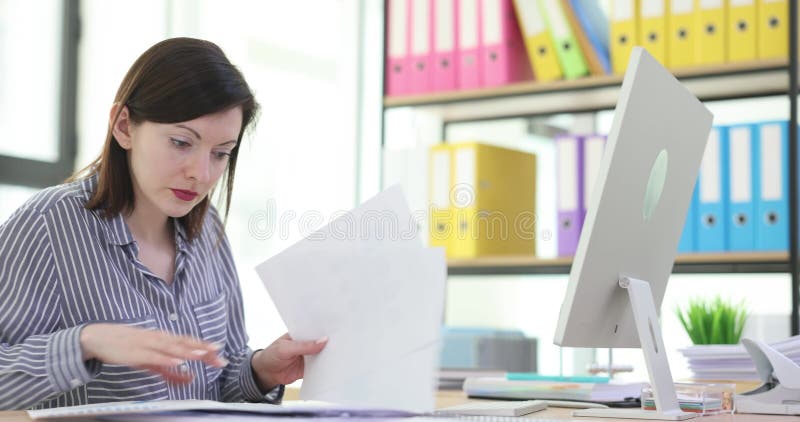 Serious Manager Secretary Sits in Office at Table and Studies Documents ...
