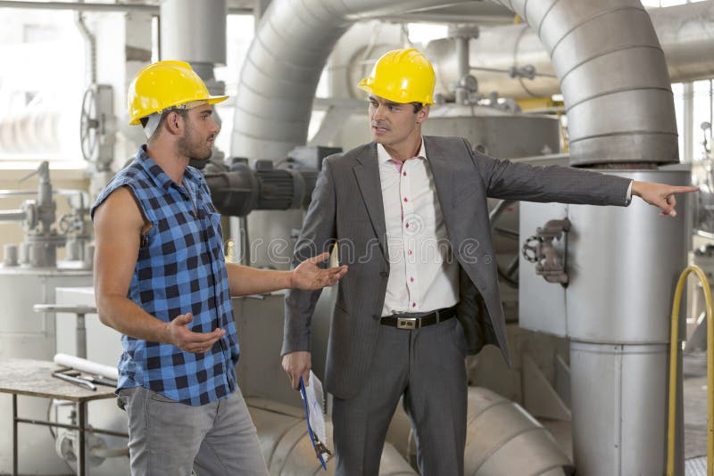 Serious Manager Showing Something To Worker in Industry Stock Photo ...