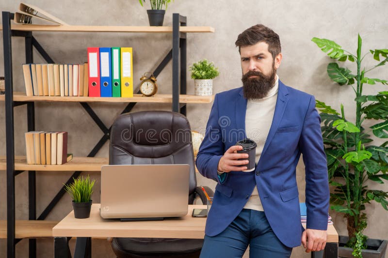 Serious Manager in Suit Drinking Tea or Coffee Sitting on Office Desk ...