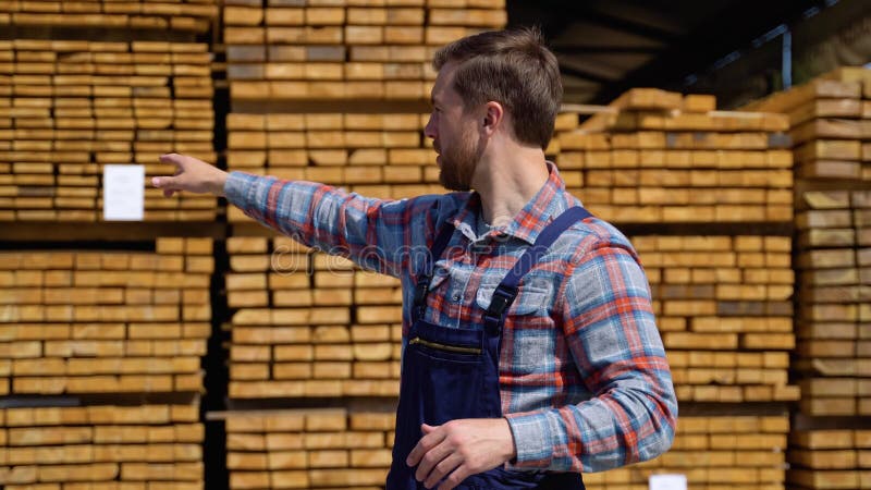 Serious Manager in Uniform Giving Commands To Workers on Timber ...