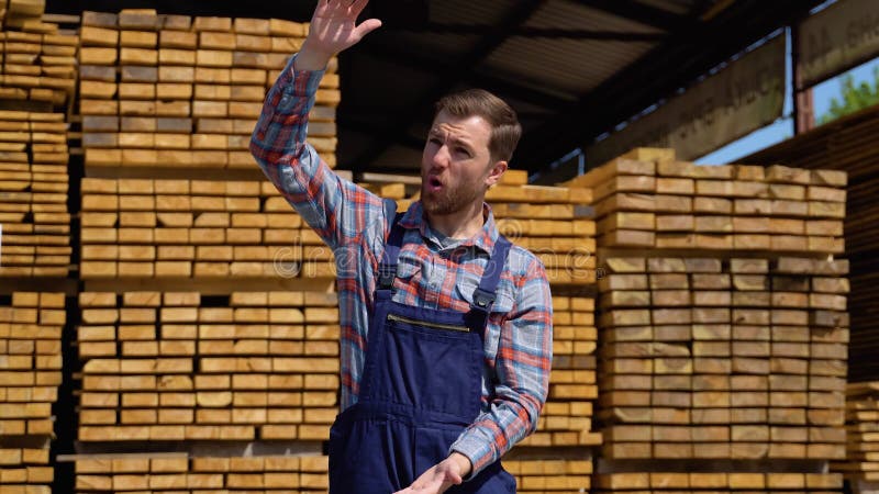Serious Manager in Uniform Giving Commands To Workers on Lumber ...