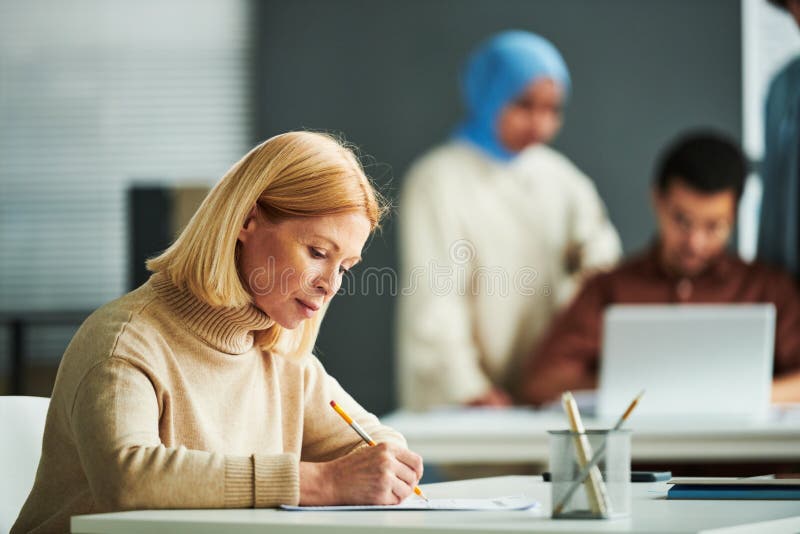 Serious Mature Blond Teacher Checking Grammar Test Stock Photo - Image ...