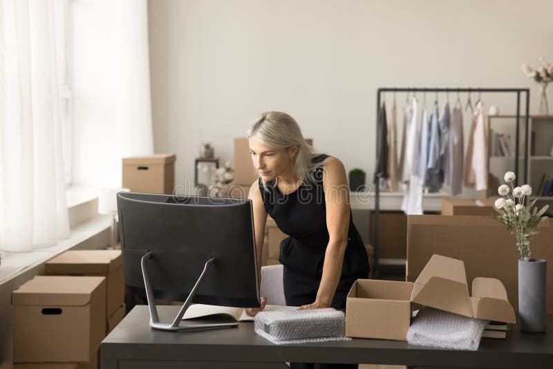 Serious Mature Internet Store Owner Using Desktop in Storage Place ...