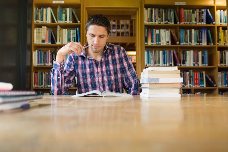 Serious Mature Student Studying at Desk in Library Stock Image - Image ...