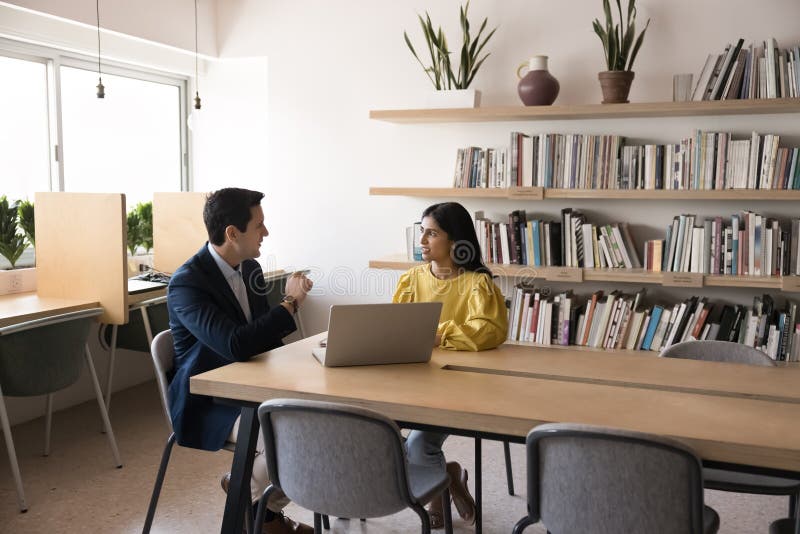 Serious Multiethnic Boss and Manager Discussing Project Strategy Stock ...