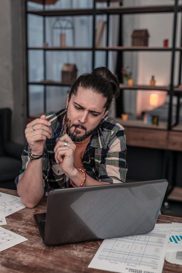 Serious Nice Young Man Holding His Glasses Stock Photo - Image of ...