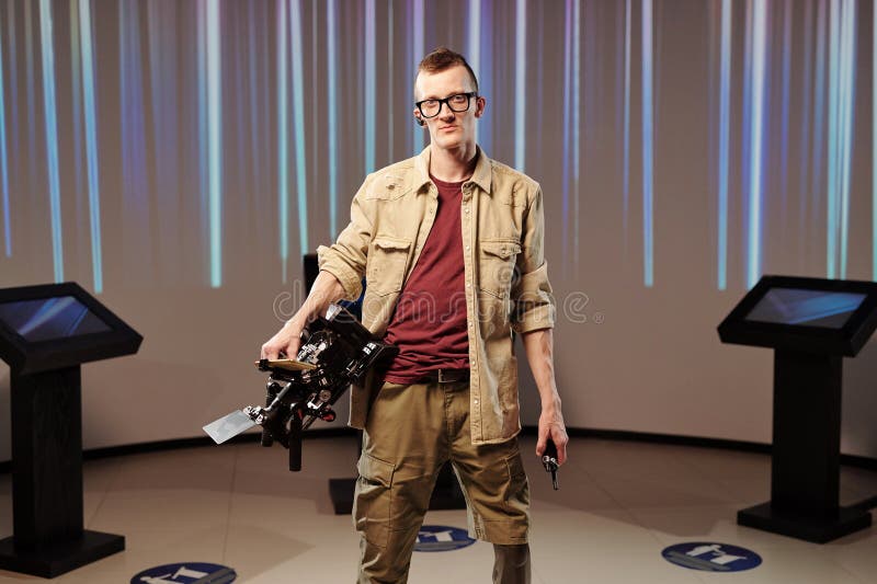 Serious Operator with Camera Standing in Studio Stock Image - Image of ...