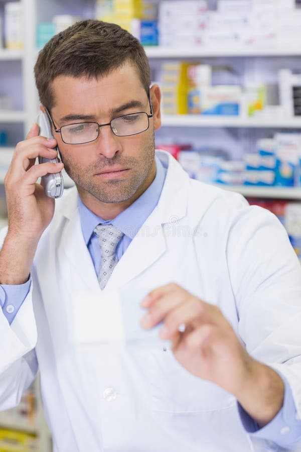Serious Pharmacist on Phone at Pharmacy Stock Image - Image of focus ...