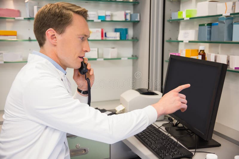 Serious Pharmacist on the Phone Using Computer Stock Photo - Image of ...