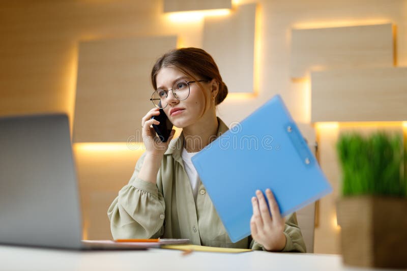 Serious Phone Conversation on the Phone in the Office, Busy Young Woman ...