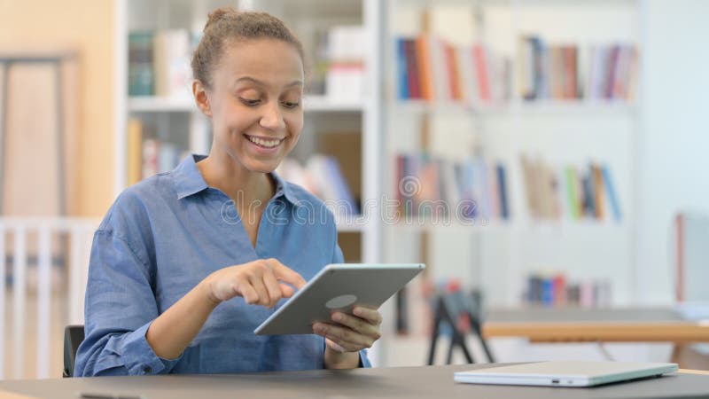 Serious Professional African Woman Using Tablet in Library Stock Image ...