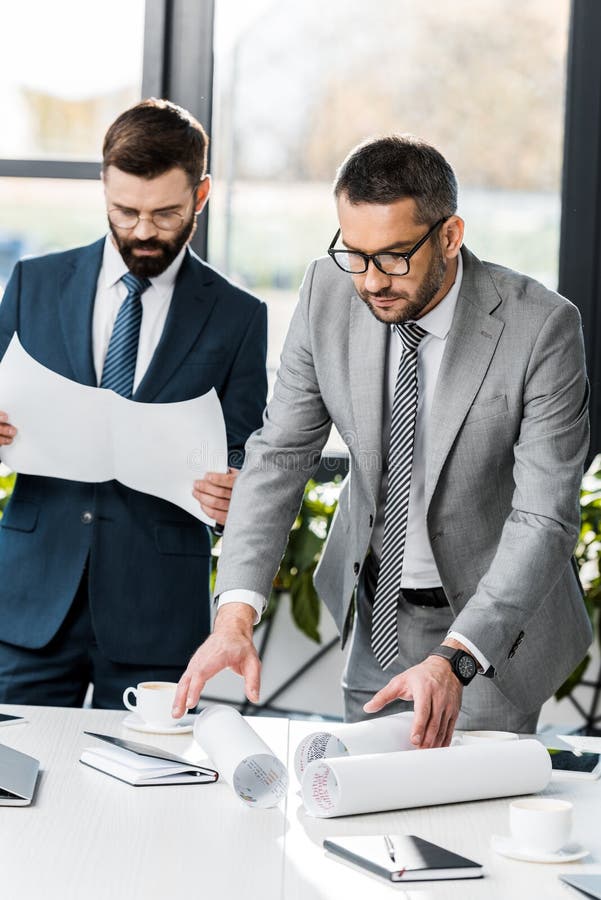 Serious Professional Businessmen Working with Papers and Blueprints ...
