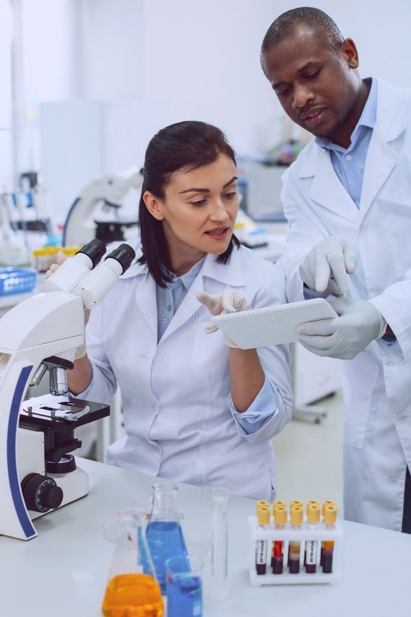 Serious Researcher Discussing Work with Her Colleague Stock Image ...