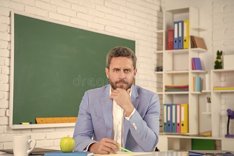 Serious School Teacher in Classroom at Blackboard Stock Image - Image of blackboard, education ...