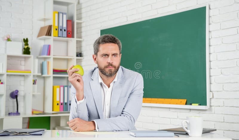 Serious School Tutor in Classroom at Blackboard Stock Photo - Image of ...