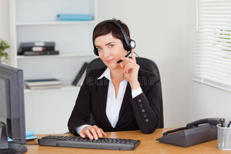 Serious Secretary Calling with a Headset Stock Photo - Image of adult ...