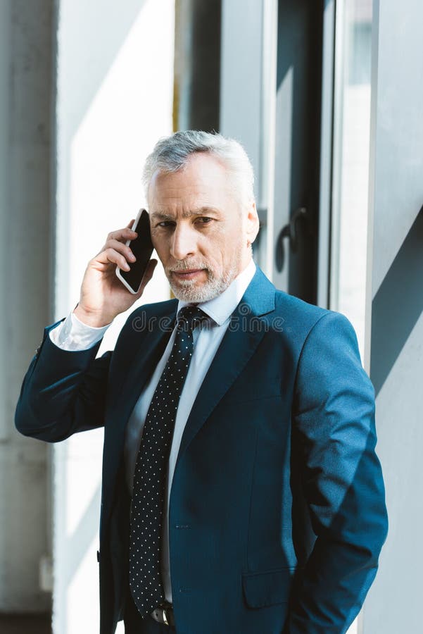 Serious Senior Businessman Talking by Smartphone and Looking Stock ...