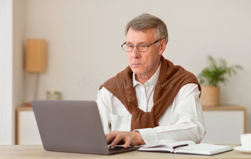 Serious Senior Gentleman at Laptop Computer Sitting in Modern Office ...
