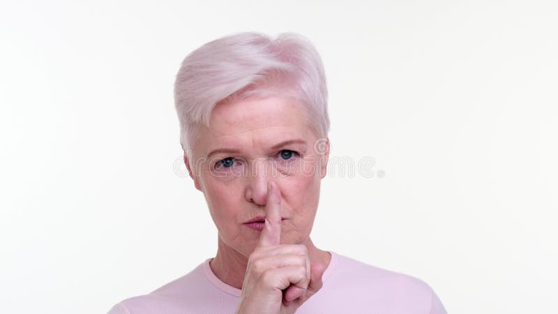 Serious Senior Woman Making Shush Gesture on White Background Stock ...