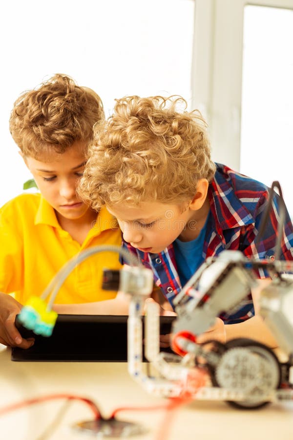 Serious Smart Boys Thinking about the Robot Stock Photo - Image of ...