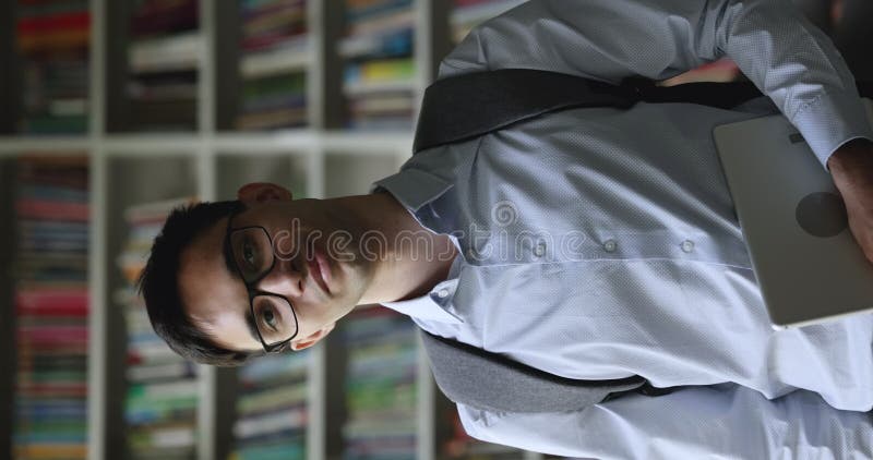 Serious Smart College Student Guy in Glasses Standing in Library Stock ...
