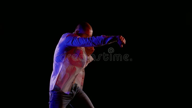 Serious Strong Man is Practicing Arm Punches, Fighter in Darkness Stock ...