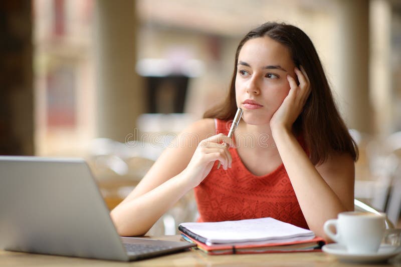 Serious Student Thinking E-learning in a Bar Terrace Stock Image ...