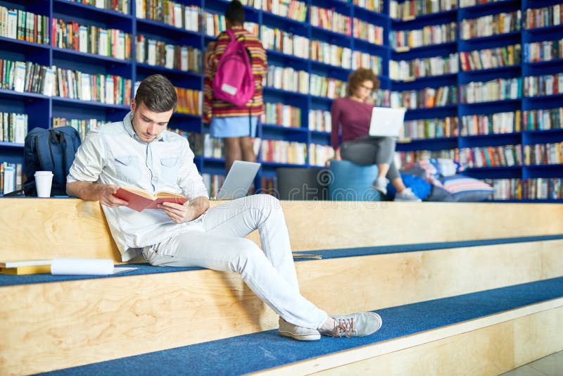 Serious Student Doing Home Task in Library Stock Image - Image of ...