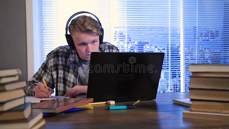 Student Learning Online with Headphones and Laptop Stock Footage ...
