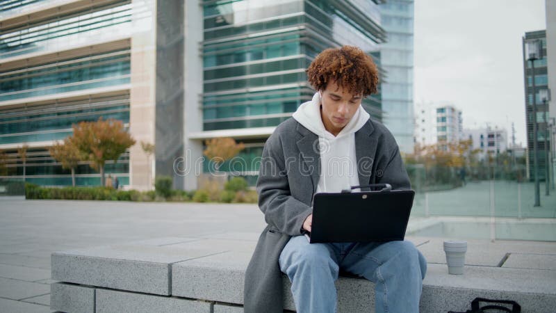 Serious Student Learning Laptop at Modern District. Focused Guy Typing ...