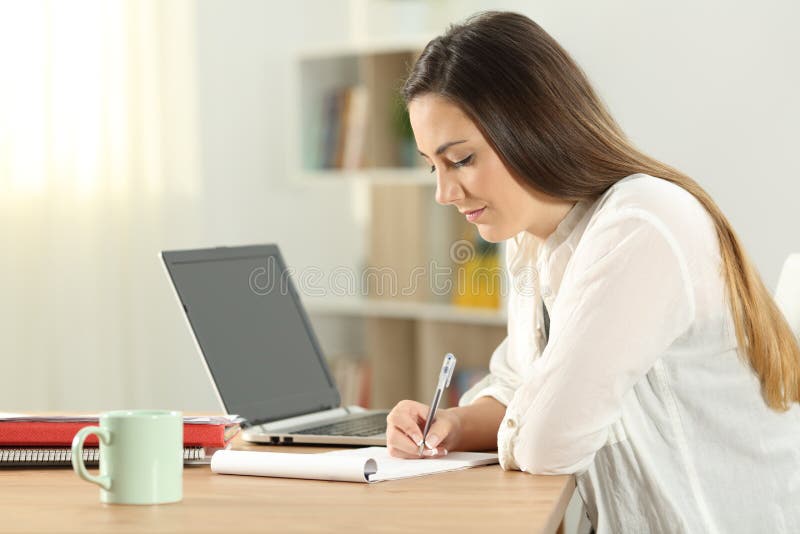Student Taking Notes in a Notebook on a Table Stock Photo - Image of ...