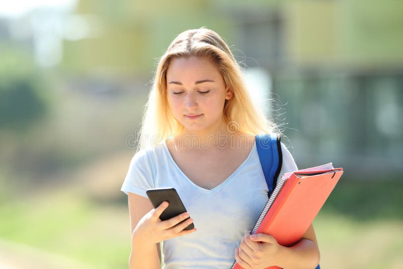 Serious Student Walks Checking Text on Phone Stock Image - Image of ...