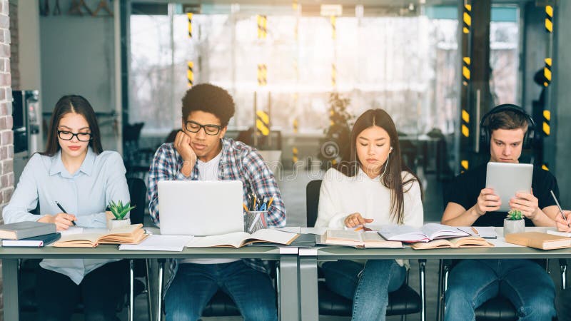 Serious Students Studying in College Library with Gadgets Stock Photo ...